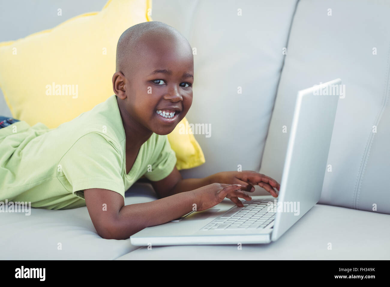 Happy boy using a laptop Stock Photo - Alamy