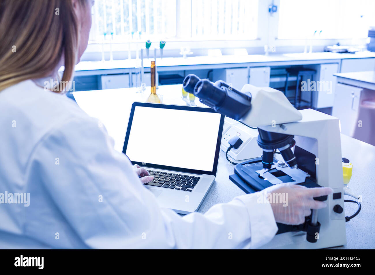 Scientist working with a microscope in laboratory Stock Photo - Alamy