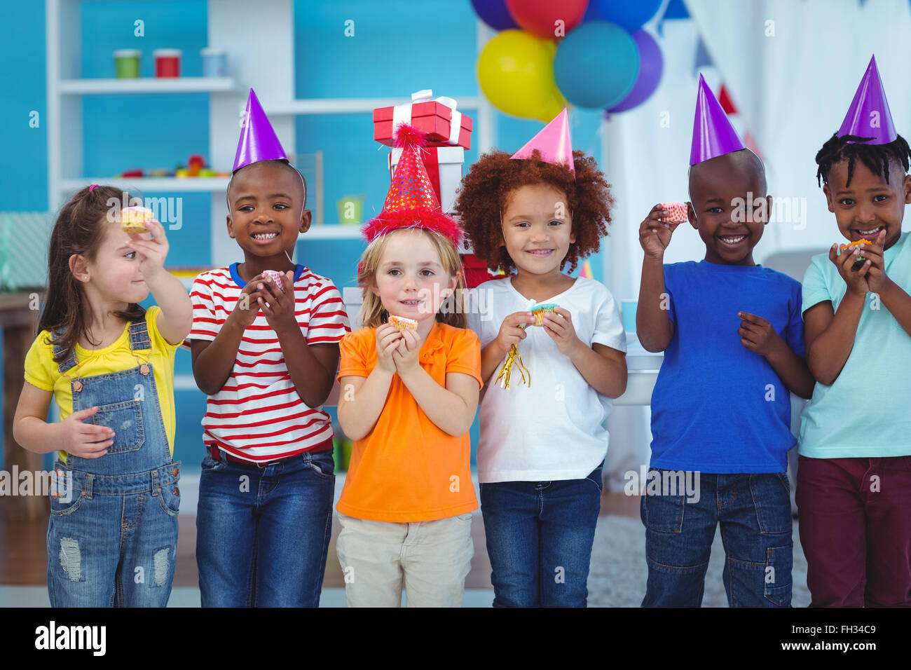 Smiling kids standing together Stock Photo - Alamy