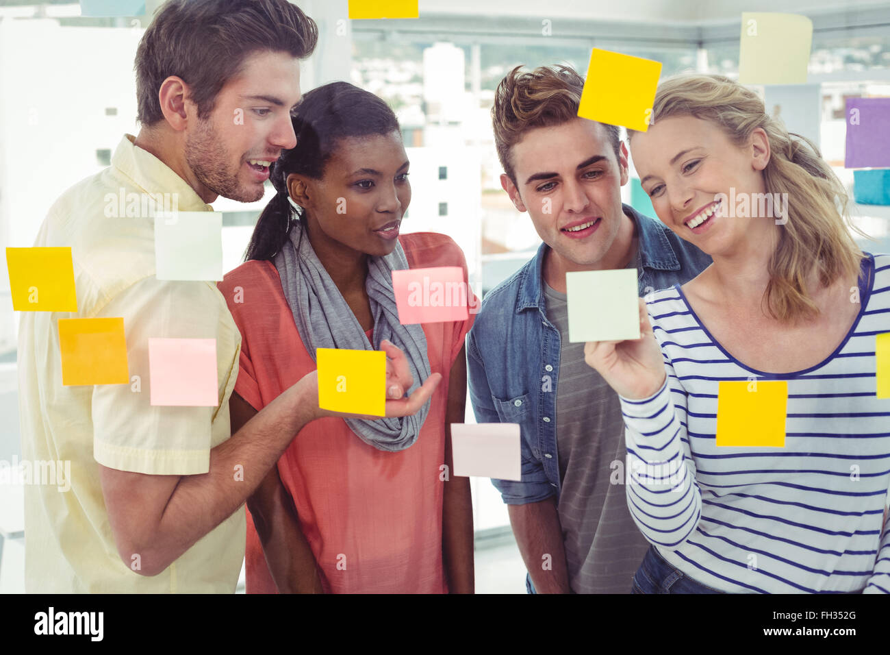 Creative team using post it notes Stock Photo - Alamy