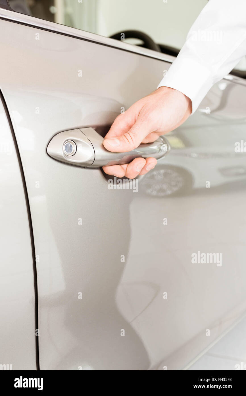 Man holding a car door handles Stock Photo - Alamy