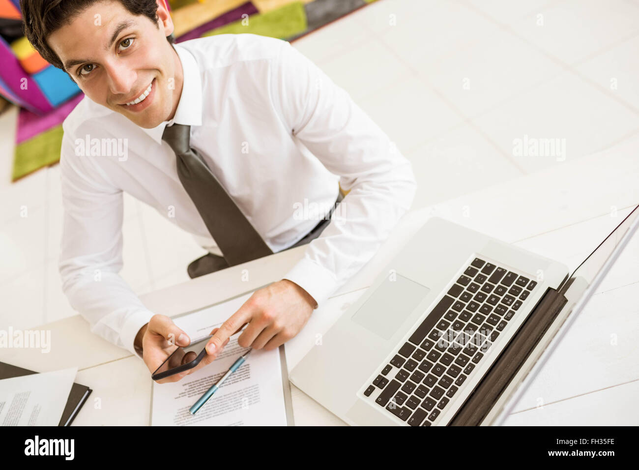 Smiling salesman having a phone call Stock Photo - Alamy