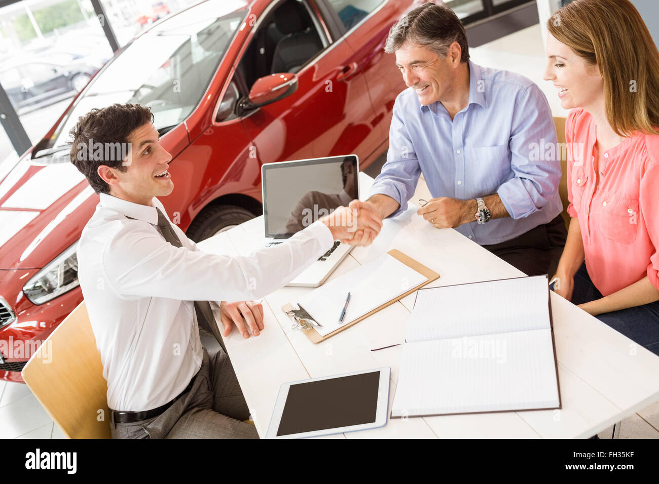 Customers signing some important documents Stock Photo - Alamy