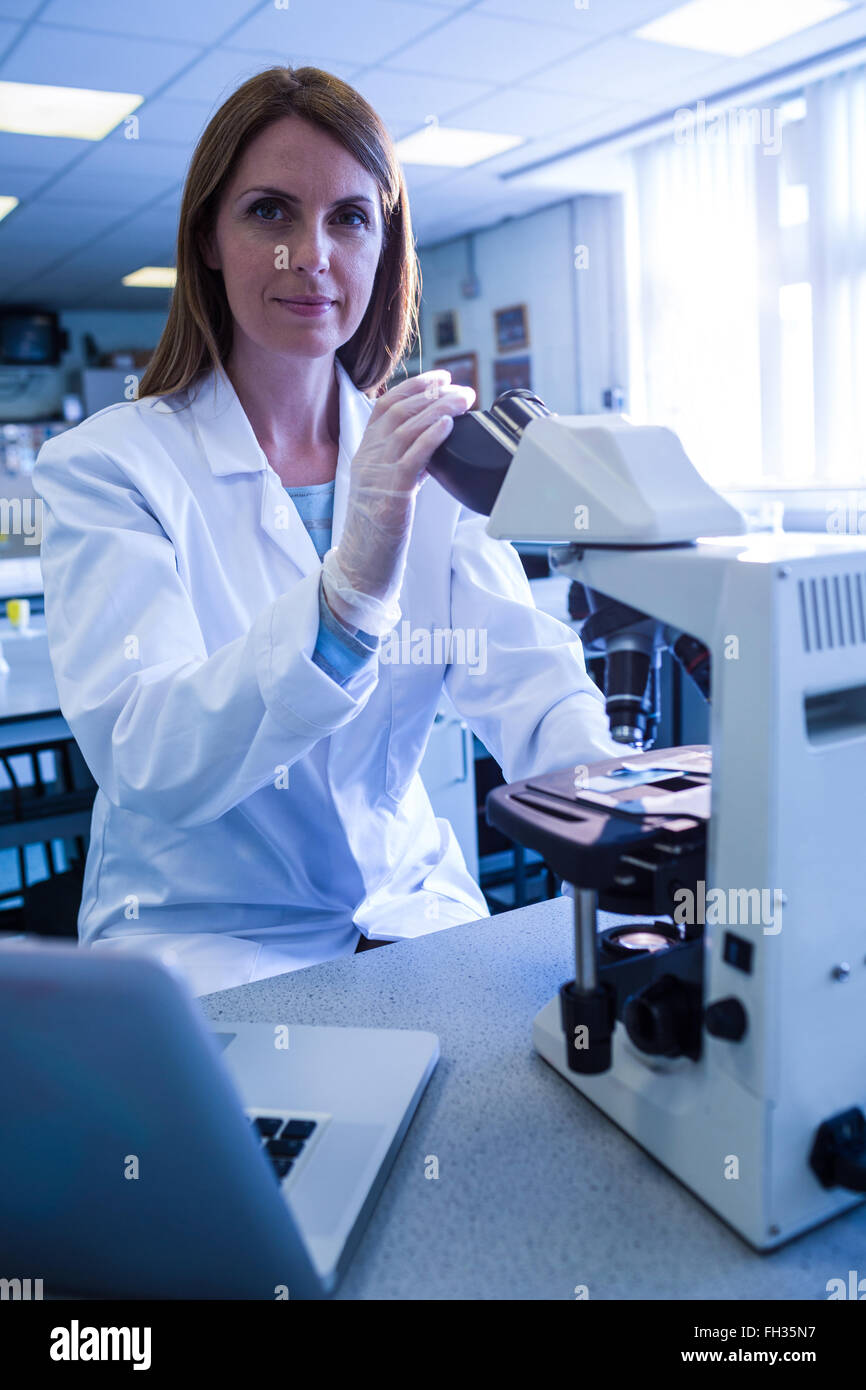 Scientist working with a microscope in laboratory Stock Photo - Alamy