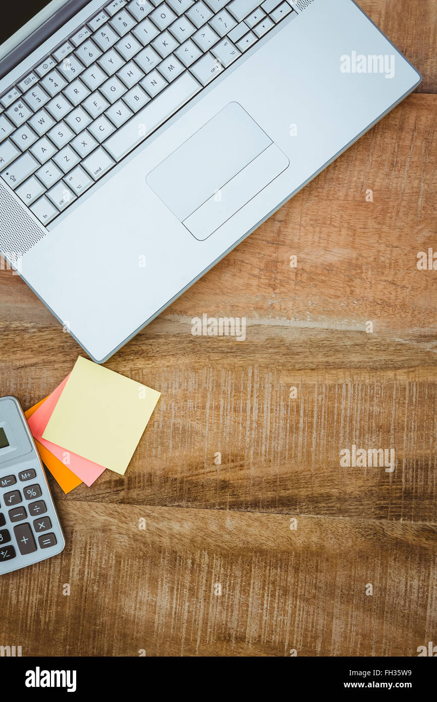 Business desk with laptop and calculator Stock Photo - Alamy