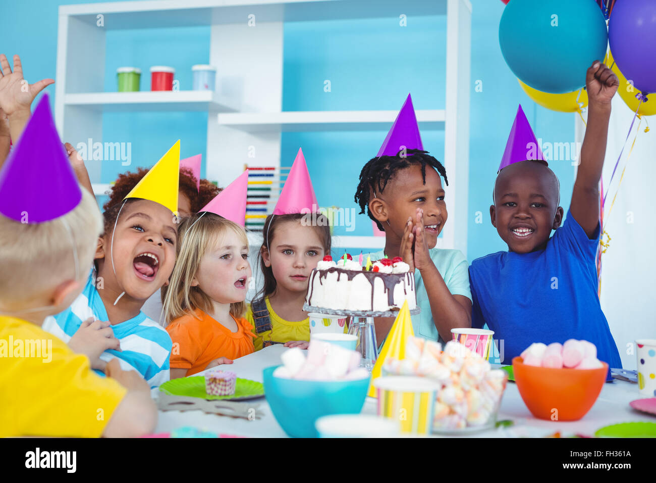 Excited kids enjoying a birthday party Stock Photo - Alamy