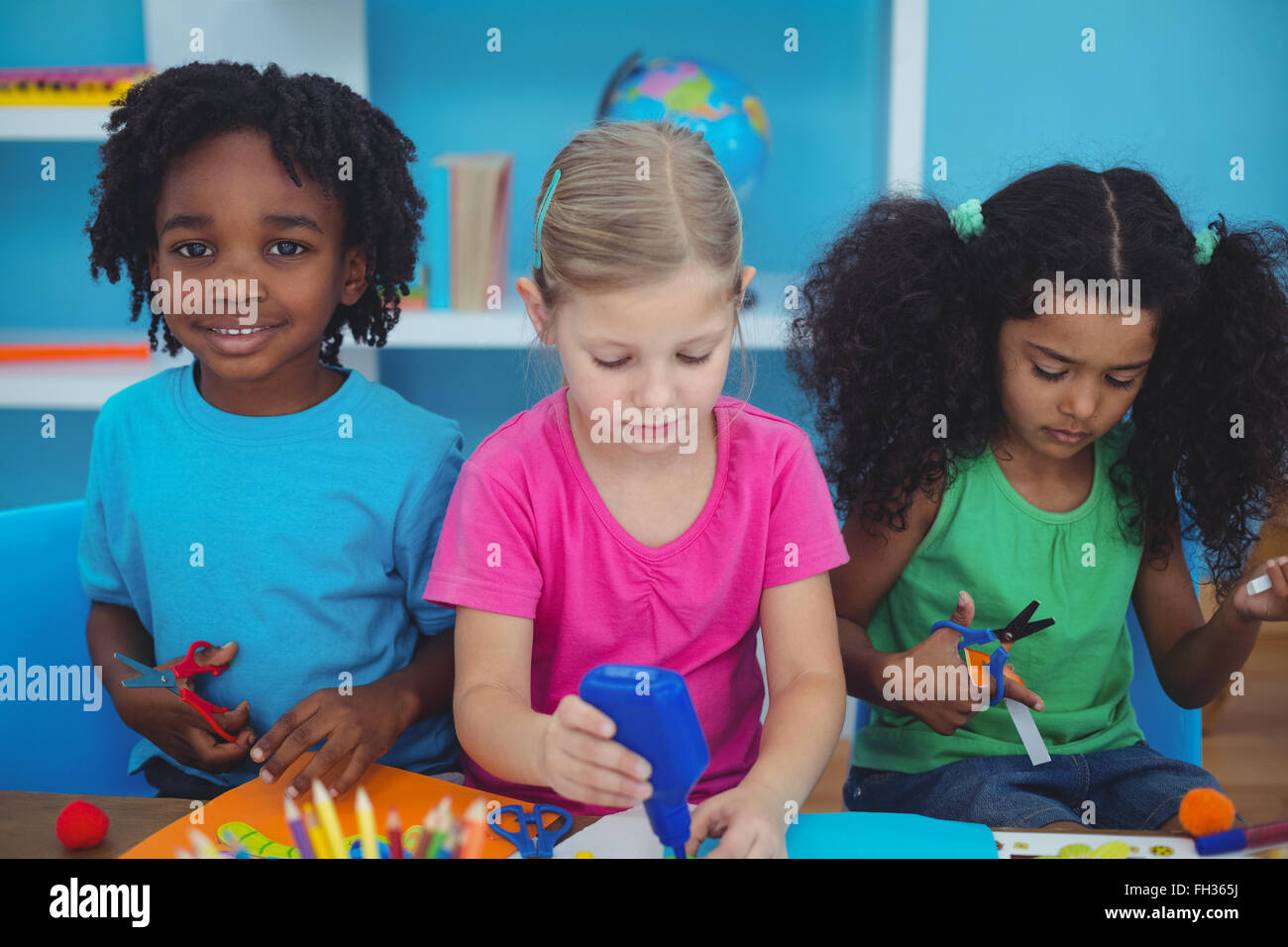 Happy kids doing arts and crafts together Stock Photo - Alamy