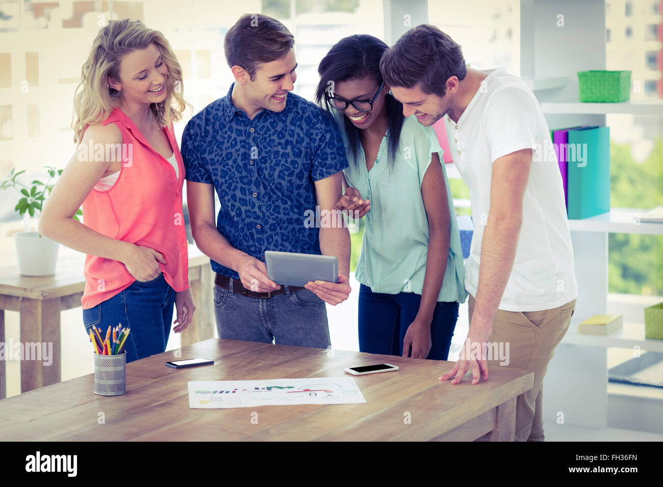 Smiling creative team working together Stock Photo - Alamy