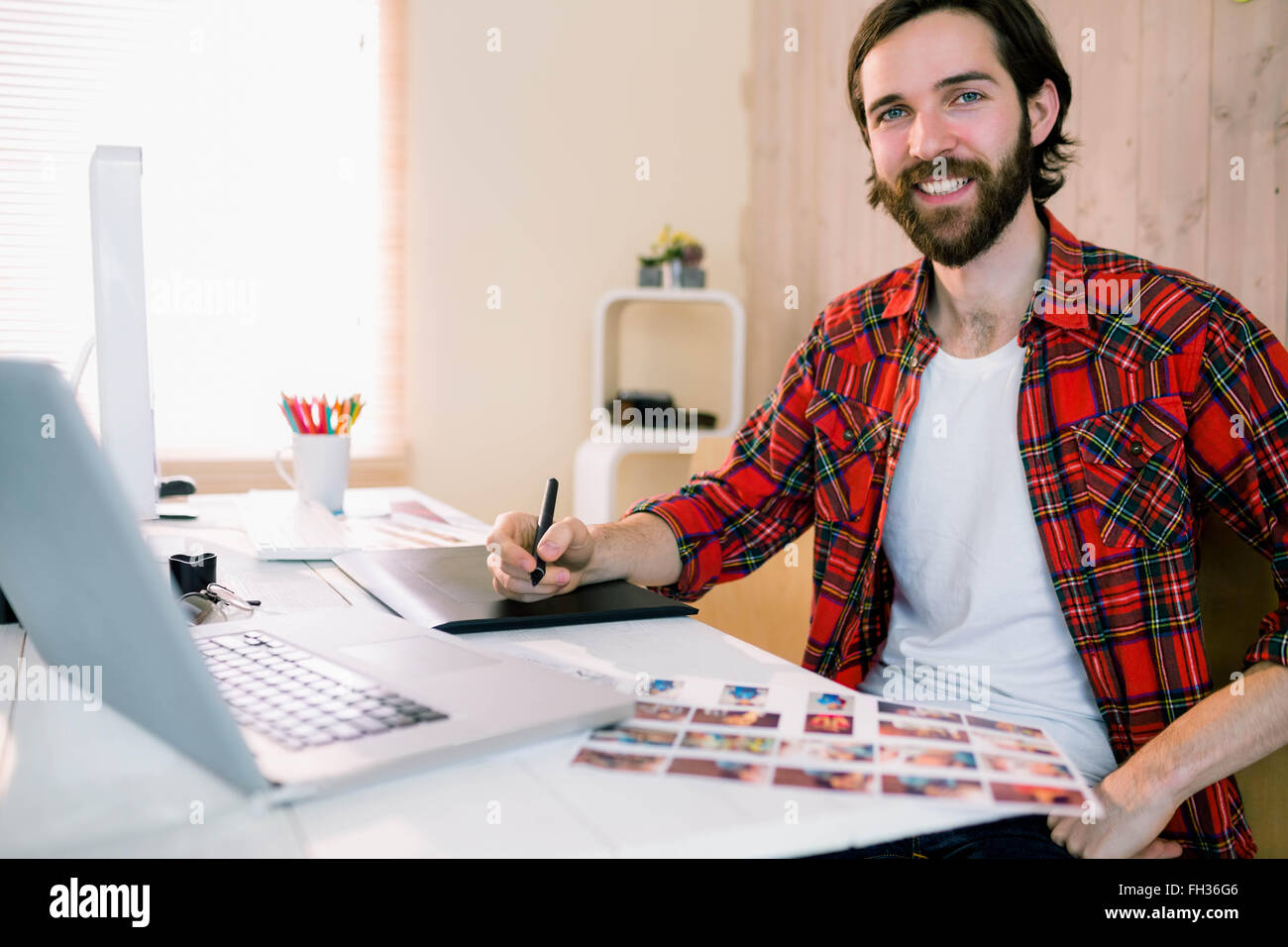 Handsome designer working at his desk Stock Photo - Alamy