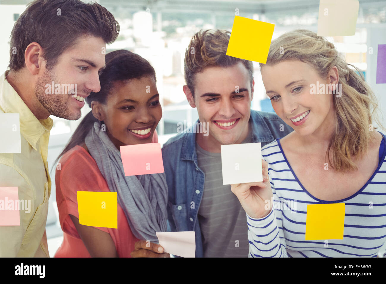 Creative team using post it notes Stock Photo - Alamy
