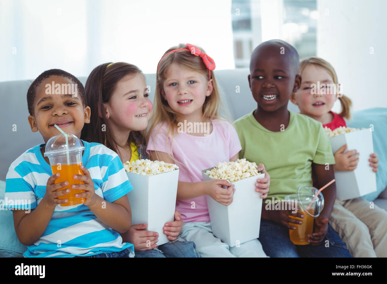 Boy enjoying popcorn watching hi-res stock photography and images - Alamy