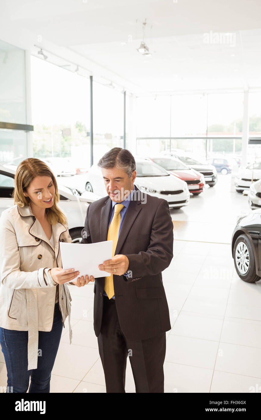 Salesman explaining the contract to a client Stock Photo - Alamy