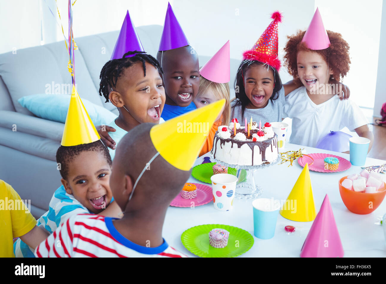 Excited kids enjoying a birthday party Stock Photo - Alamy