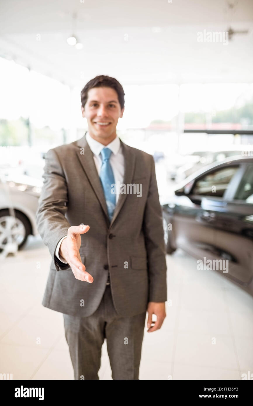 Smiling salesman ready to shake hand Stock Photo - Alamy