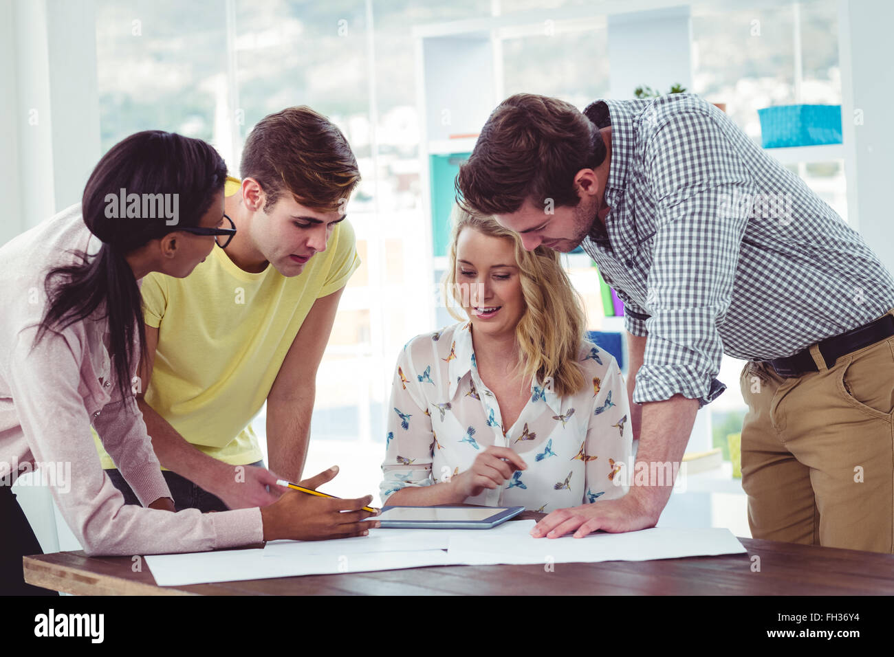 Creative business team working on a tablet together Stock Photo - Alamy