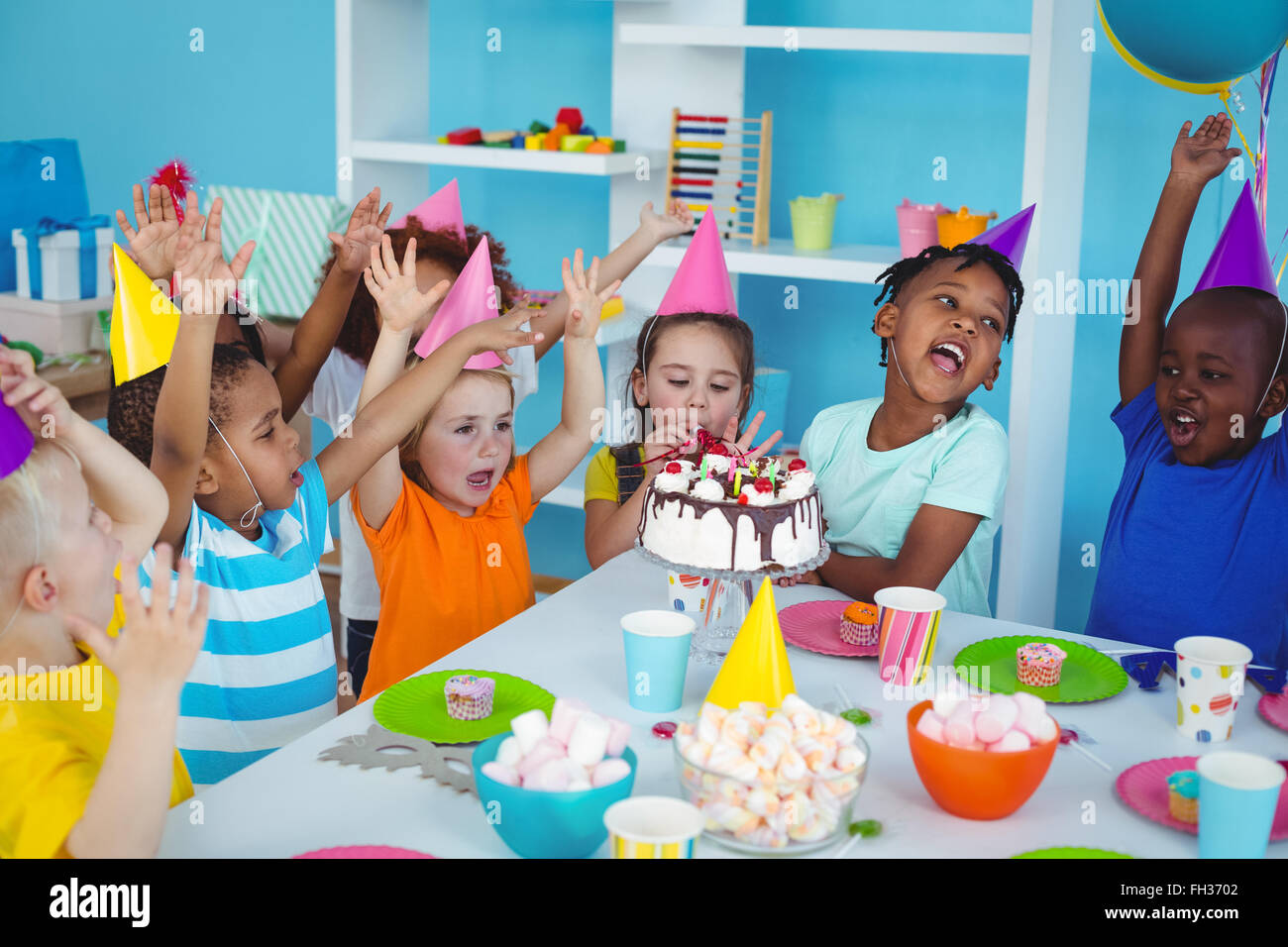 Excited kids enjoying a birthday party Stock Photo - Alamy