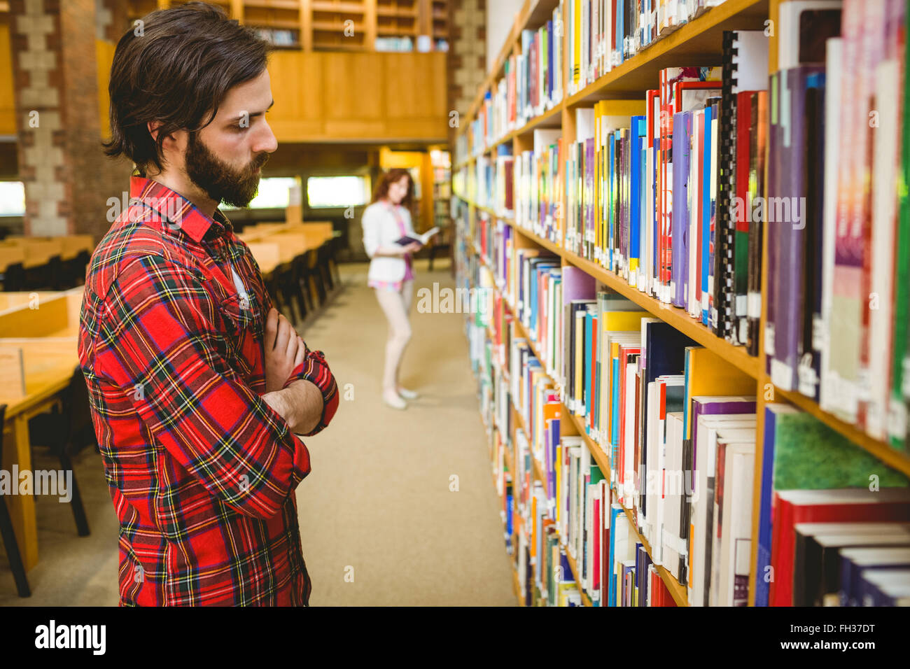 Female student selecting book hi-res stock photography and images - Alamy
