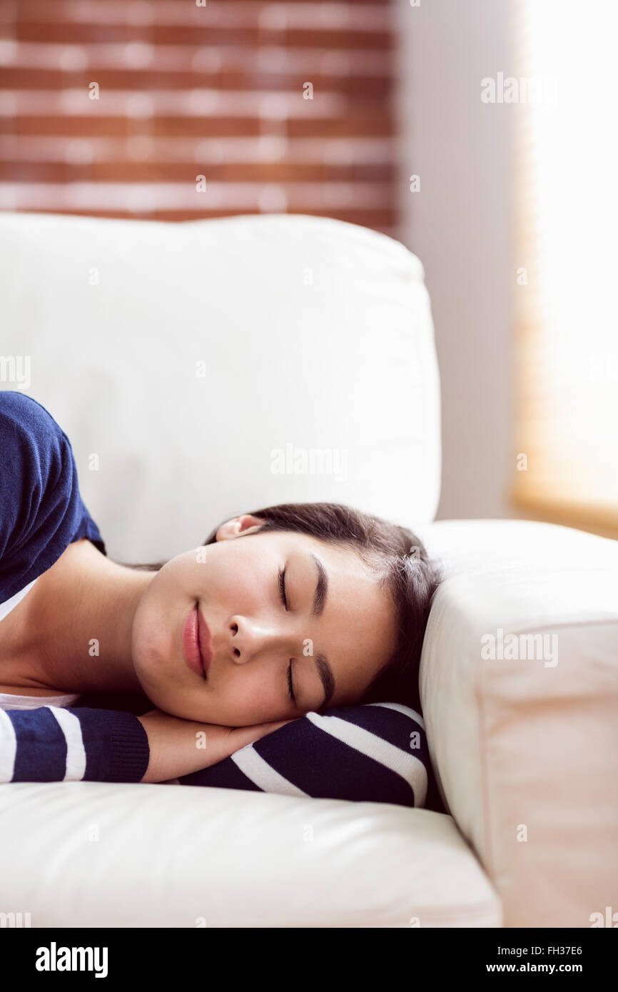 Asian woman napping on the couch Stock Photo - Alamy
