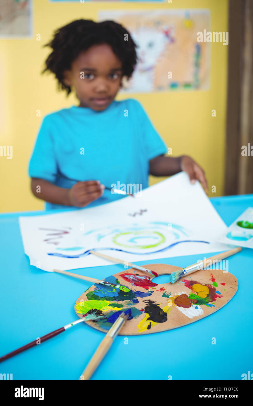 Happy kid painting on a sheet Stock Photo - Alamy