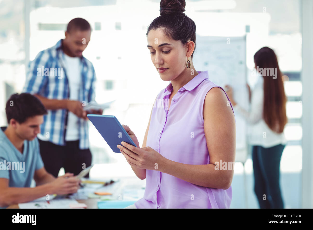 Young creative worker using tablet Stock Photo - Alamy