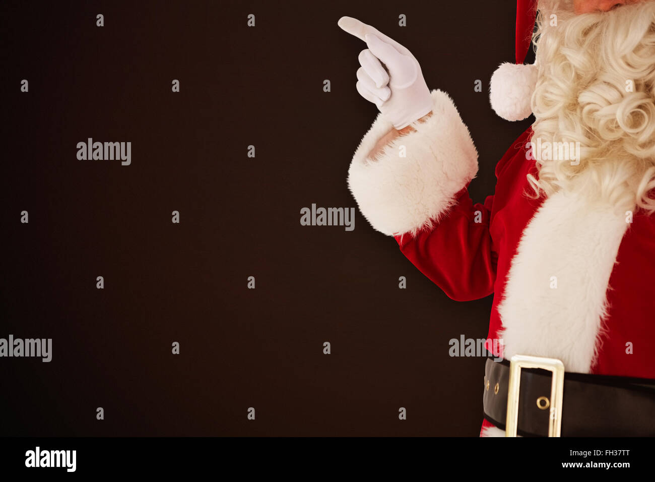 Composite image of mid section of santa pointing Stock Photo - Alamy