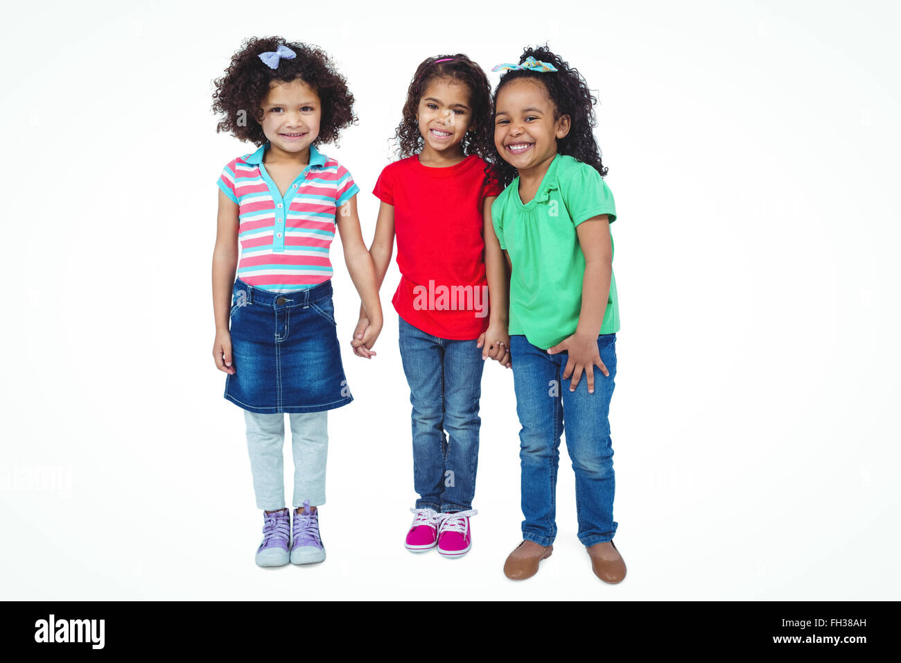 Three small girls standing together Stock Photo - Alamy