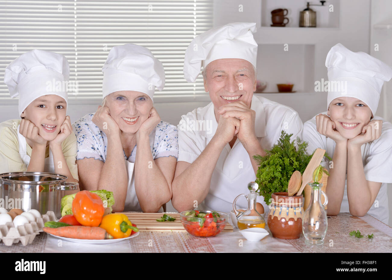 Happy family cooking together Stock Photo - Alamy