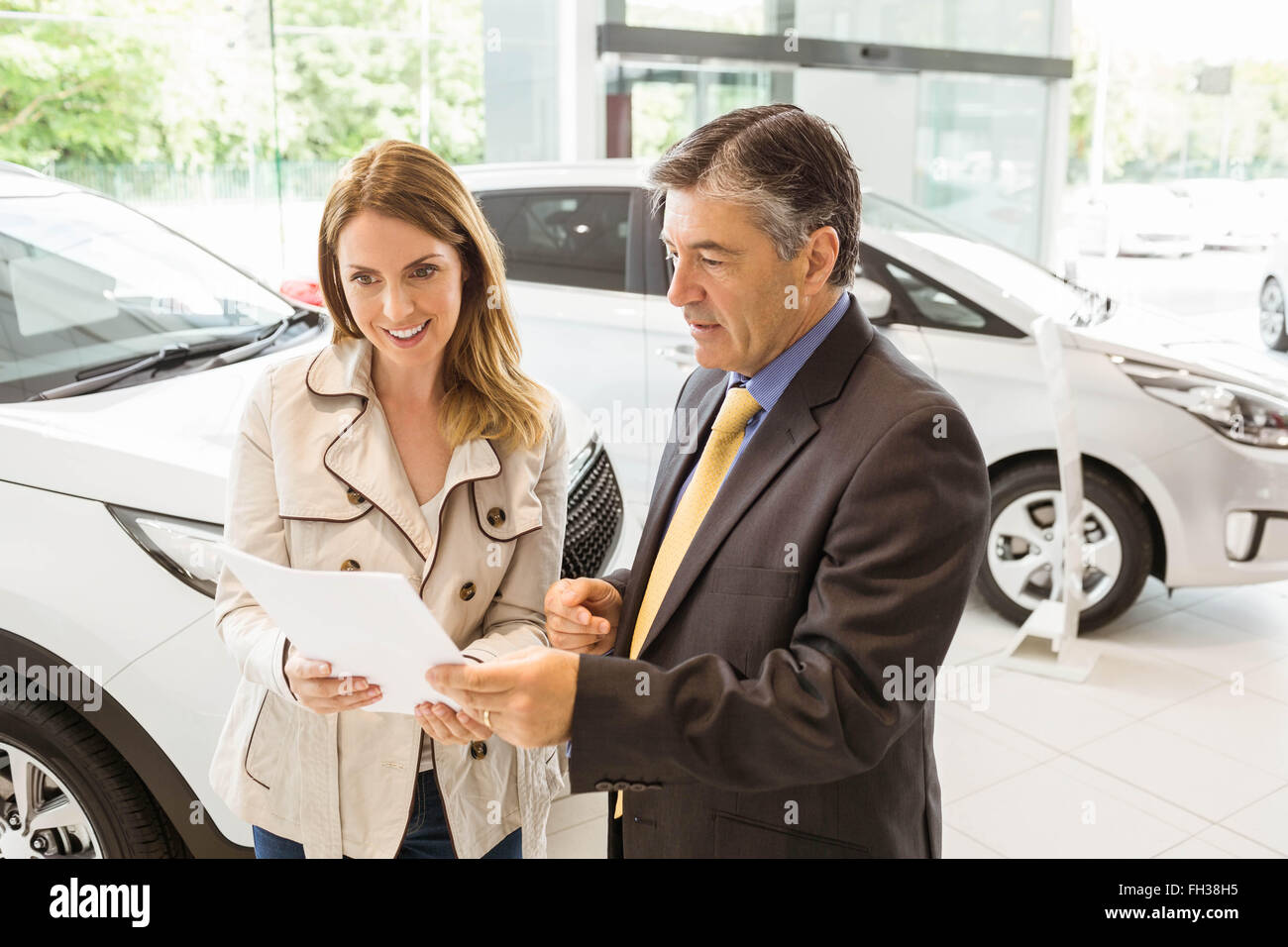 Salesman explaining the contract to a client Stock Photo - Alamy