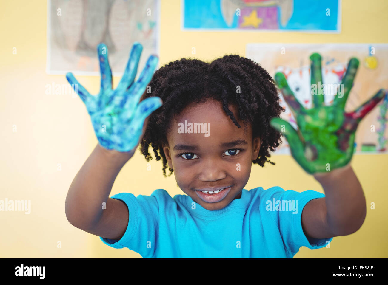 Smiling kid holding up his hands Stock Photo - Alamy