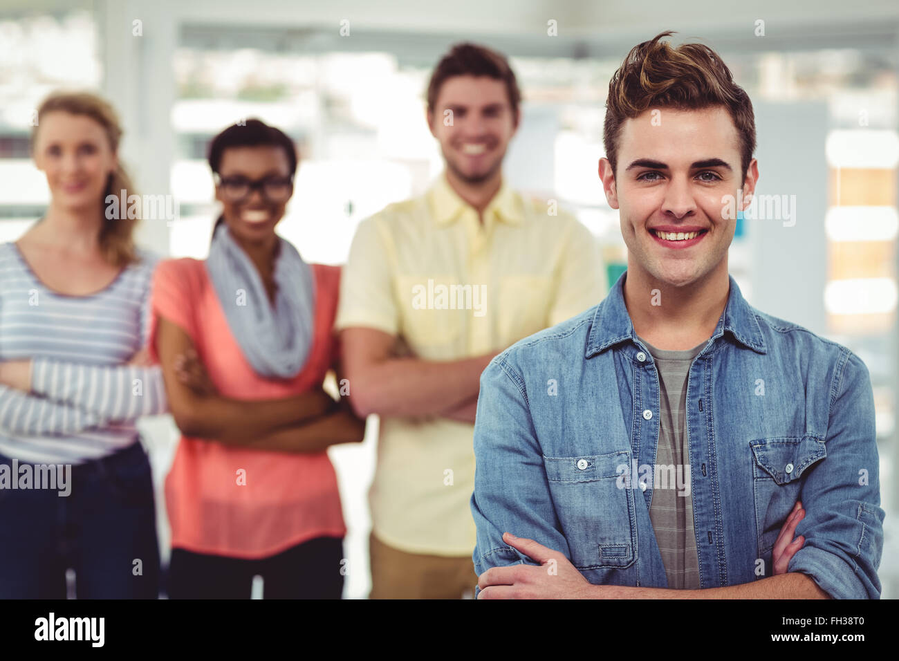 Happy creative team standing together Stock Photo - Alamy