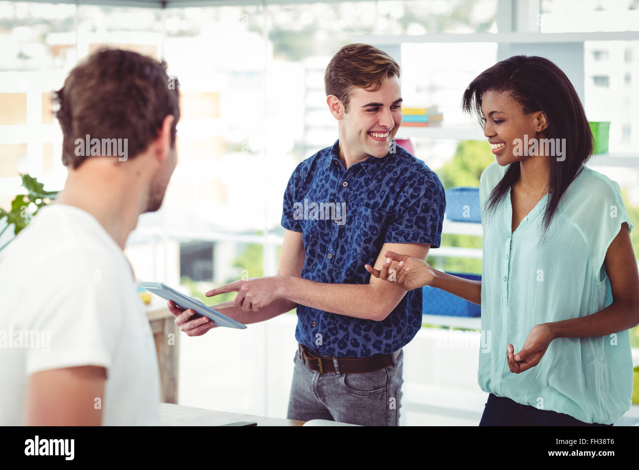 Smiling creative team working together Stock Photo - Alamy