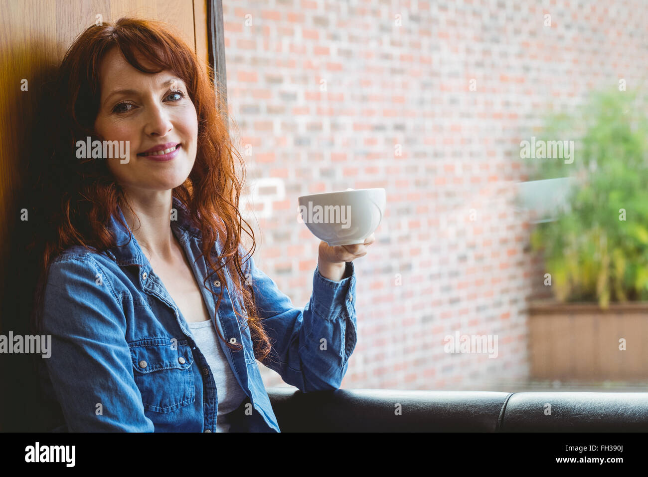 Mature student having coffee in cafe Stock Photo - Alamy