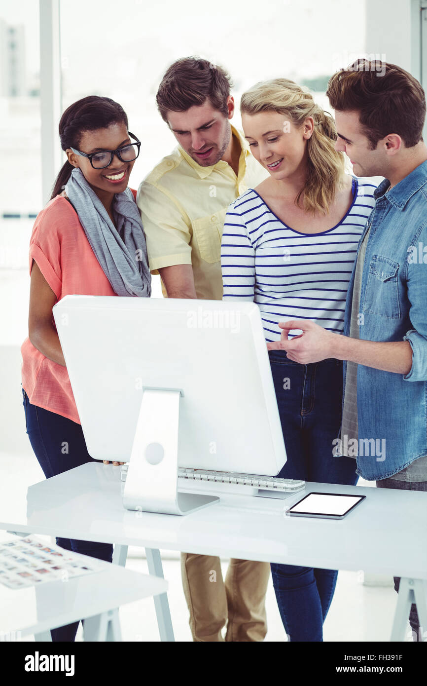 Creative business team working hard together on pc Stock Photo - Alamy