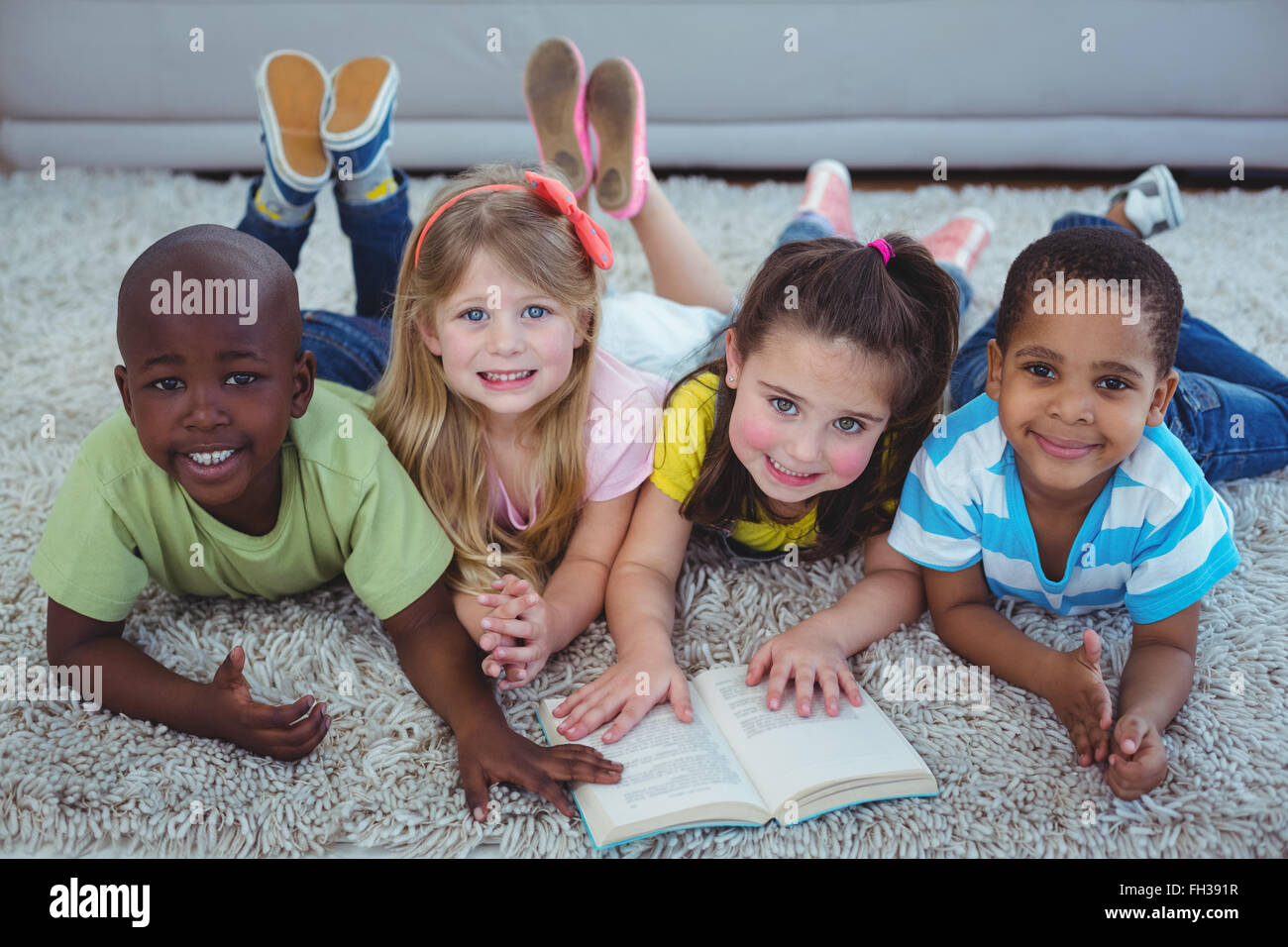 Happy kids reading a book together Stock Photo - Alamy