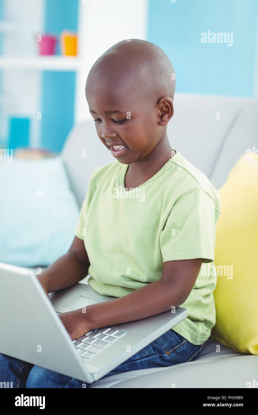 Happy boy using a laptop Stock Photo - Alamy