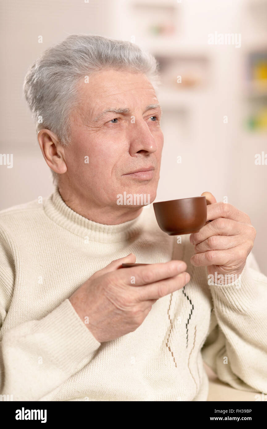 Elderly man drinking cup of coffee Stock Photo - Alamy