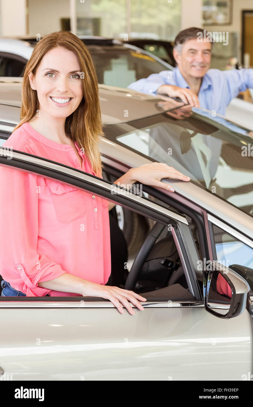 Smiling couple leaning on car Stock Photo - Alamy
