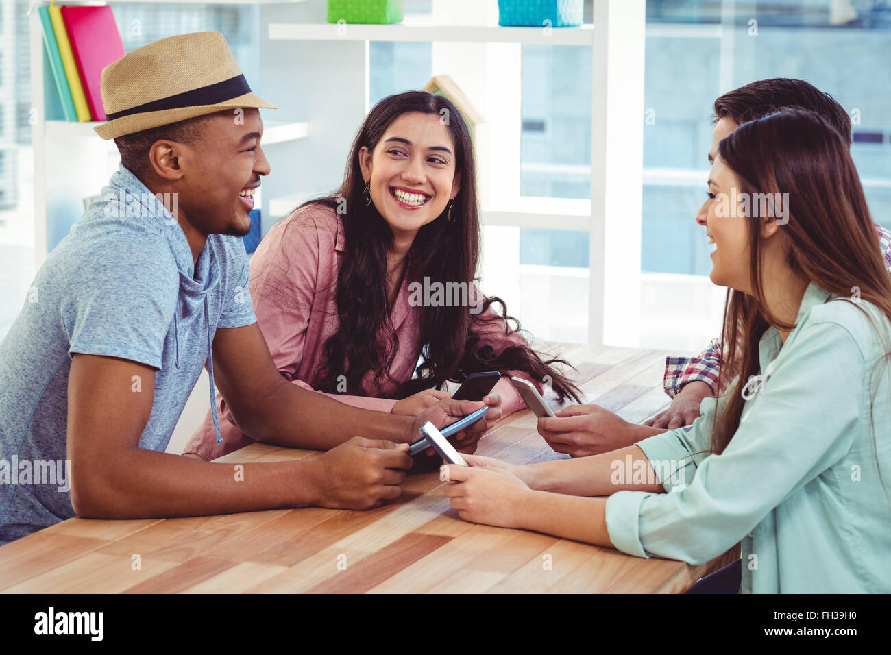 Young creative team using phones Stock Photo - Alamy