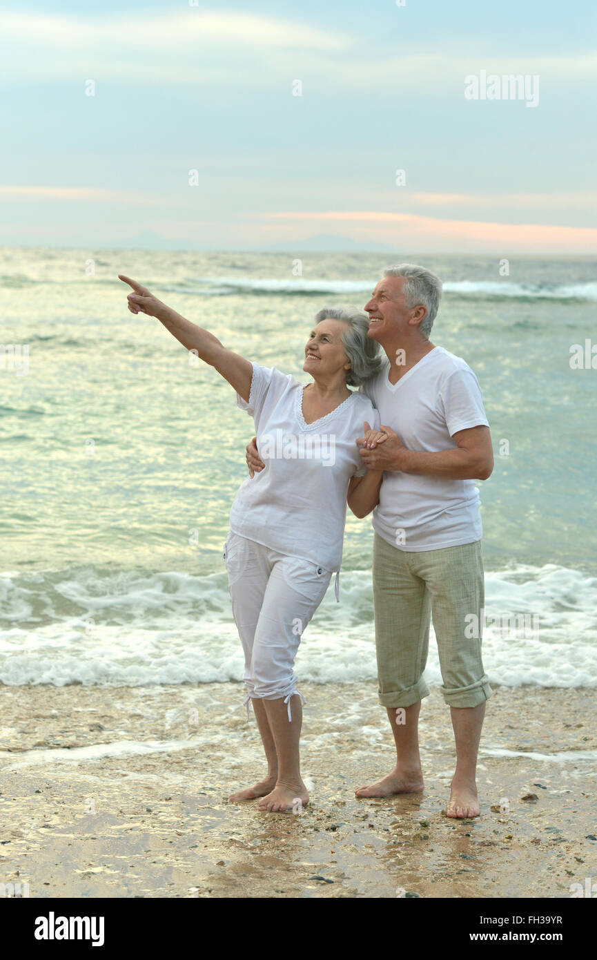 Mature couple hugging on beach hi-res stock photography and images - Alamy