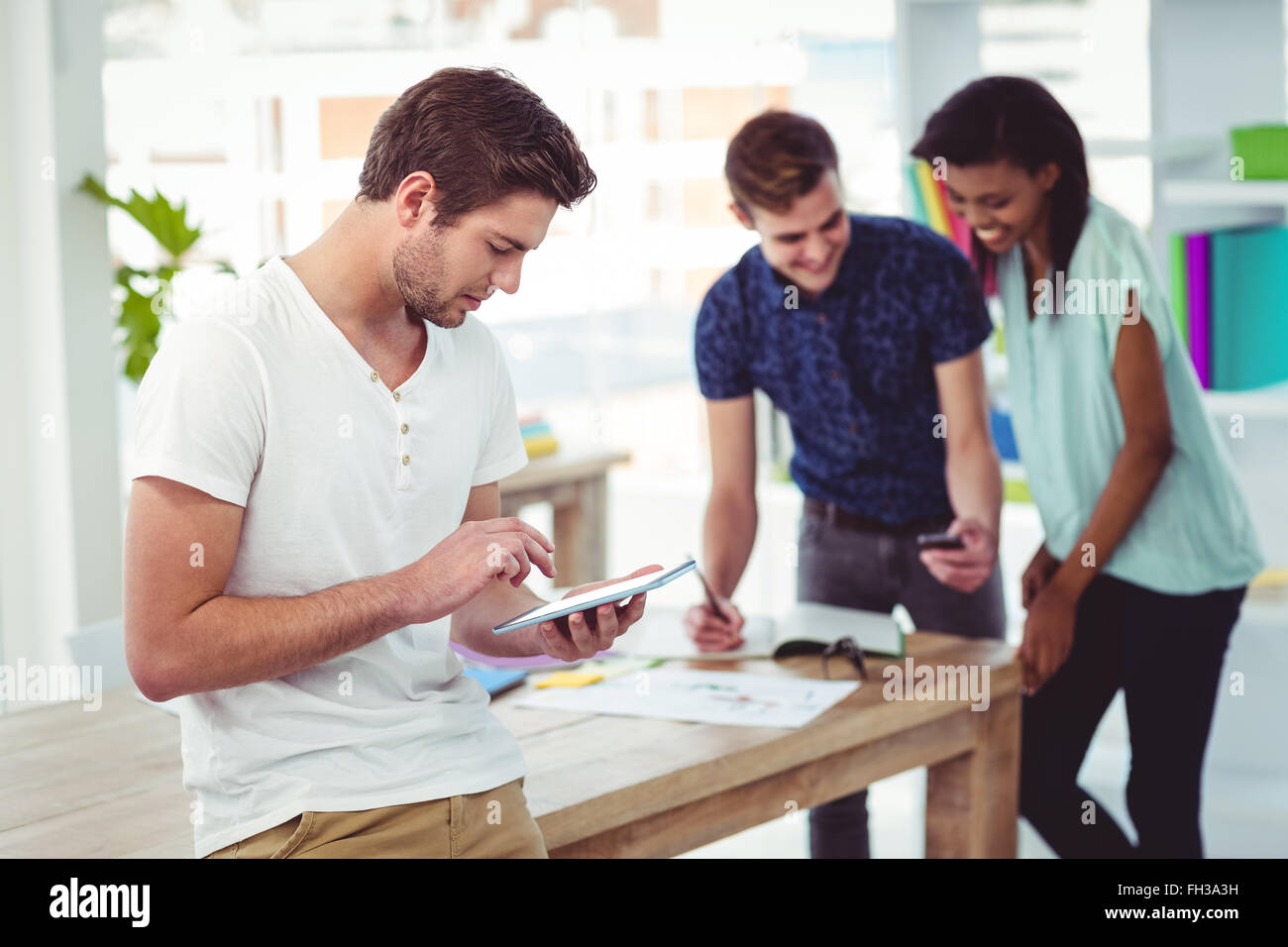 Smiling creative team working together Stock Photo - Alamy