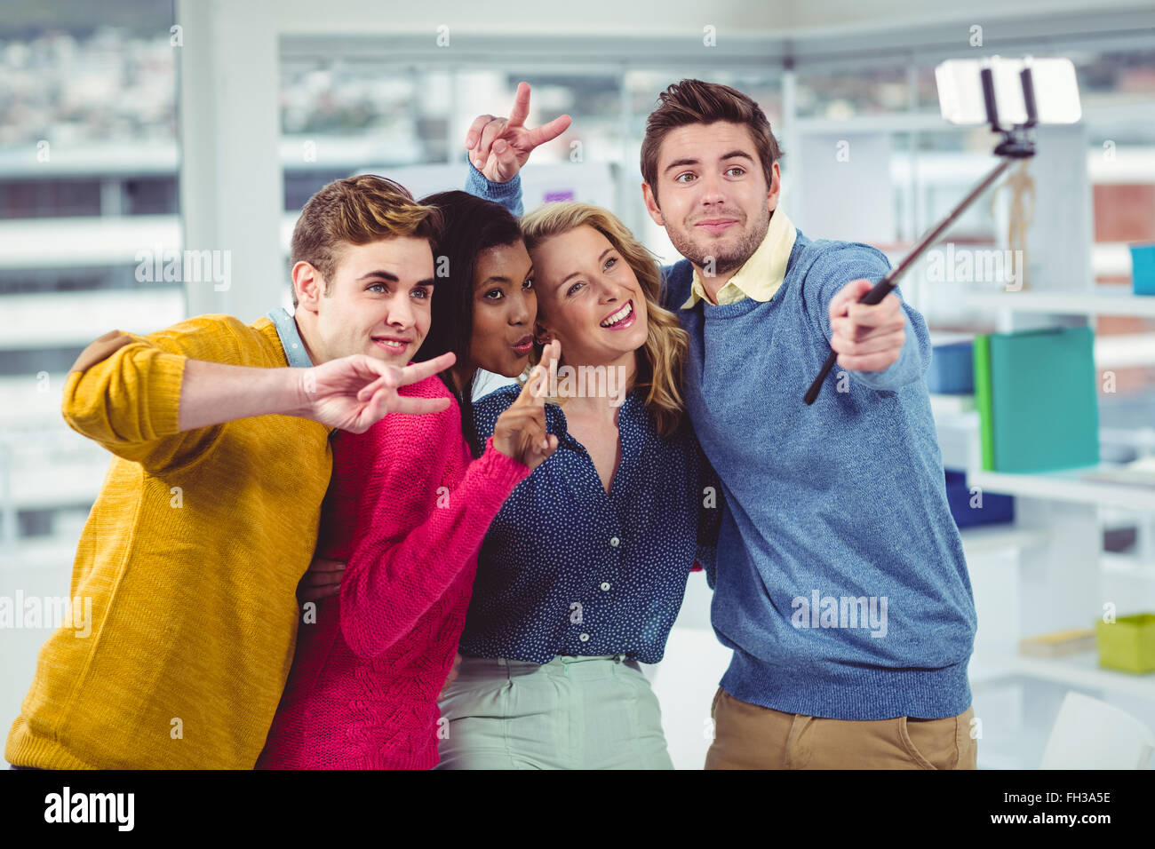 Smiling creative team posing for a selfie Stock Photo - Alamy