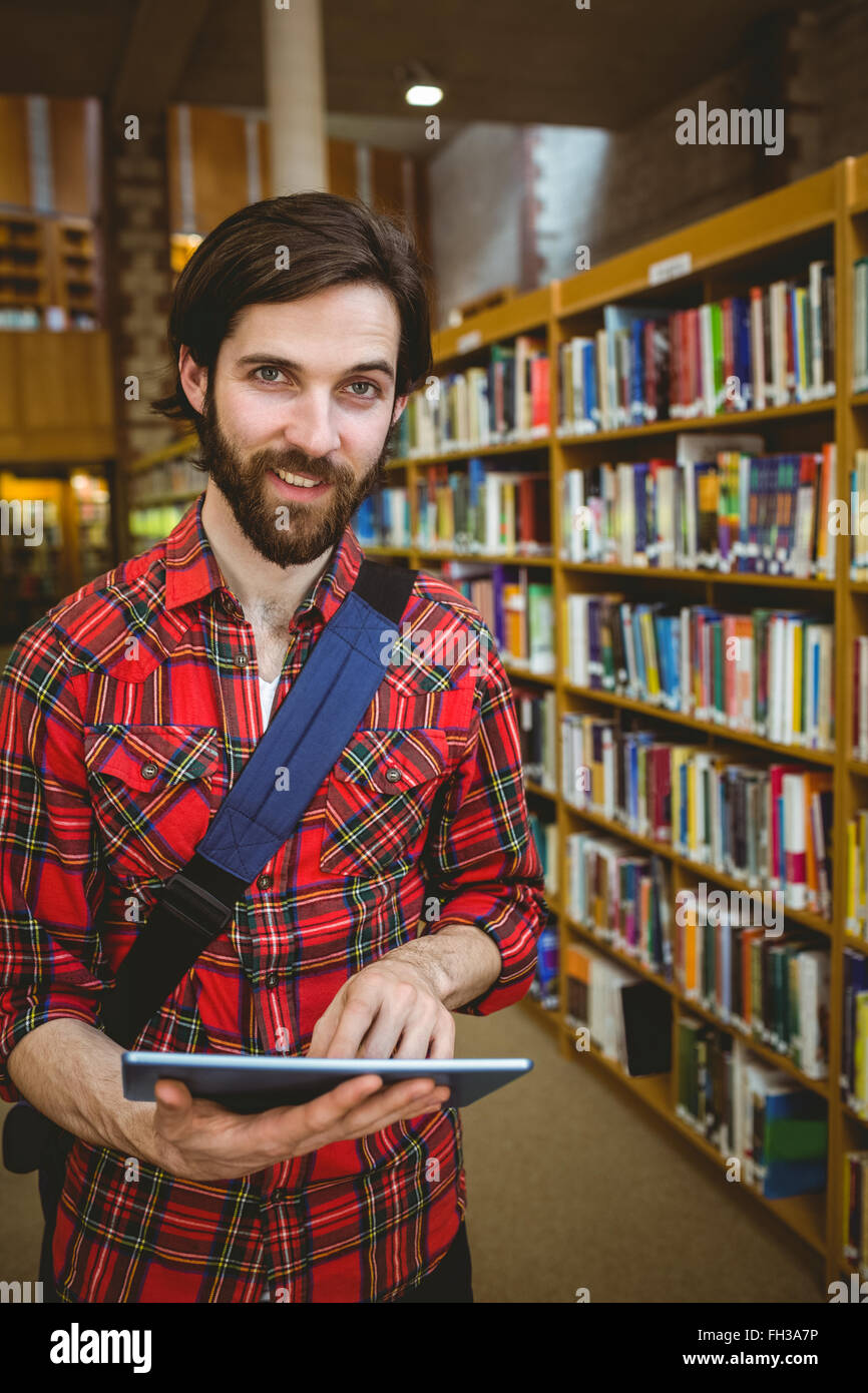 Student using his tablet in library Stock Photo - Alamy