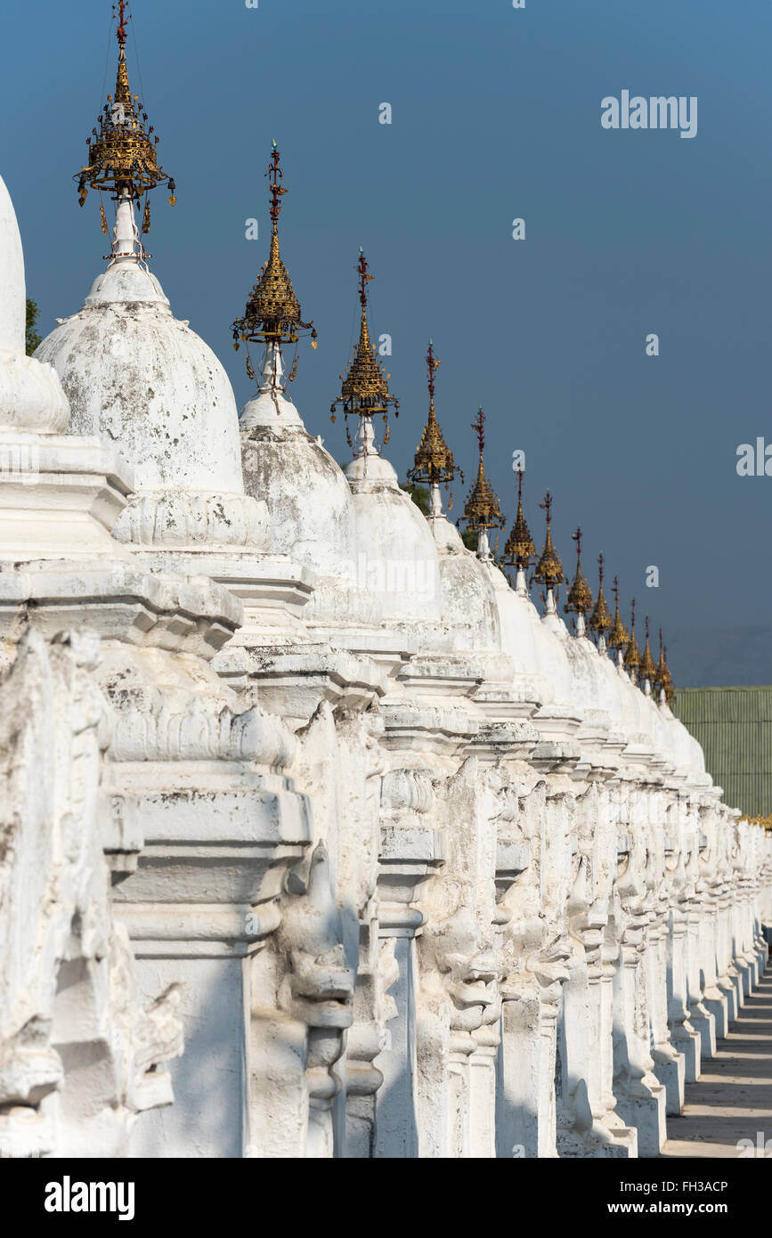 Row of white kyauksa gu stupas at Kuthodaw Pagoda in Mandalay, Burma ...