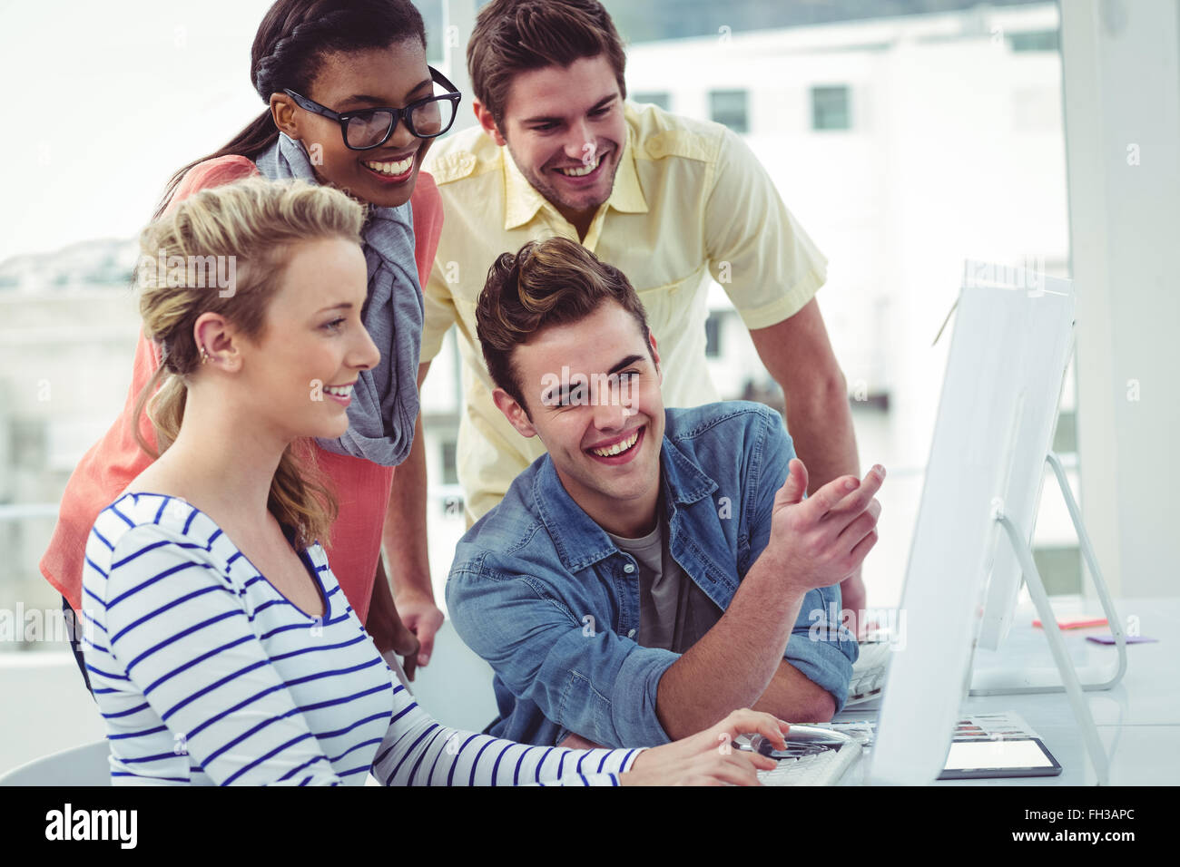 Creative business team working hard together on pc Stock Photo - Alamy