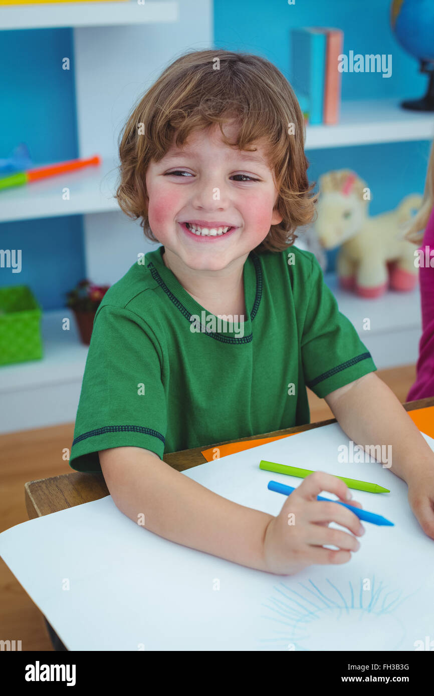 Young boy drawing on paper Stock Photo - Alamy