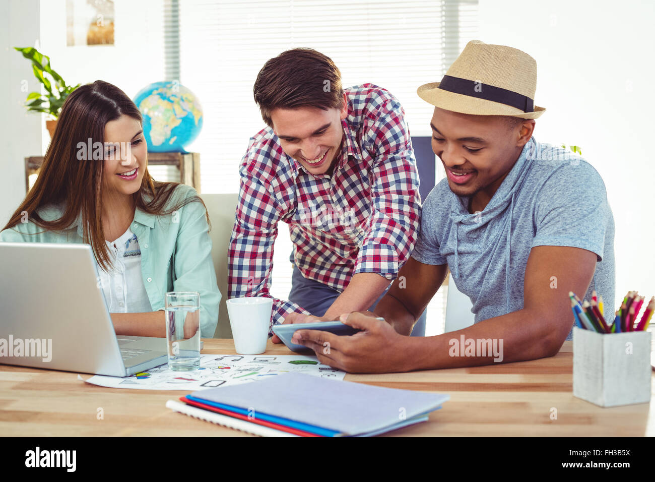 Young creative team working together Stock Photo - Alamy