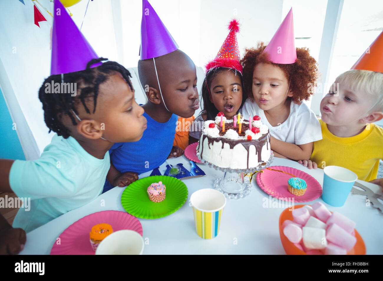 Excited kids enjoying a birthday party Stock Photo - Alamy
