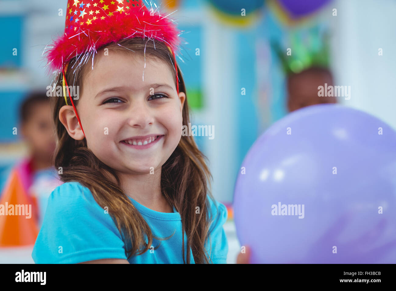 Happy kid holding a balloon Stock Photo - Alamy