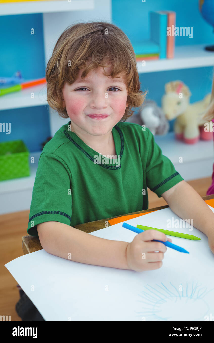 Young boy drawing on paper Stock Photo - Alamy