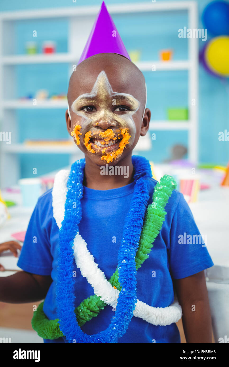 Smiling kid with icing on his face Stock Photo - Alamy
